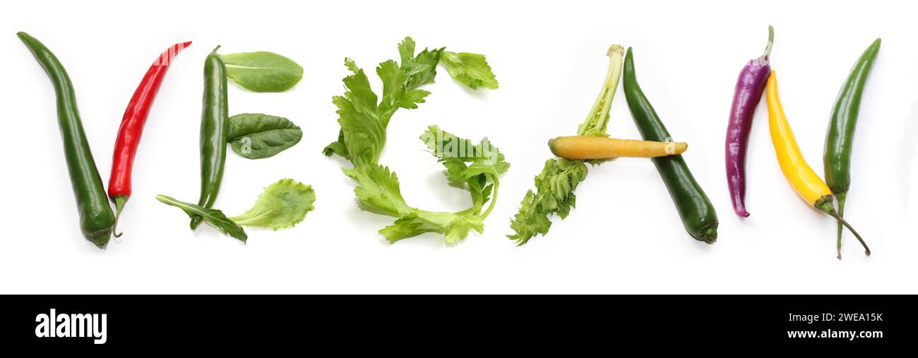 word VEGAN from green, yellow, purple chili peppers, salad lettuce ...