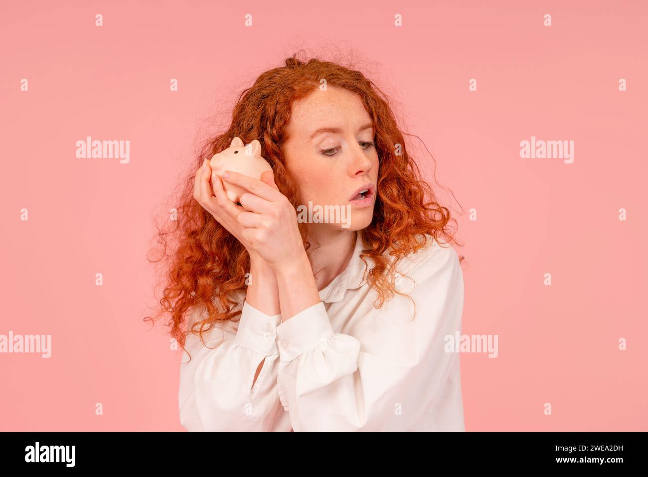Woman in white shirt listening hi-res stock photography and images - Alamy