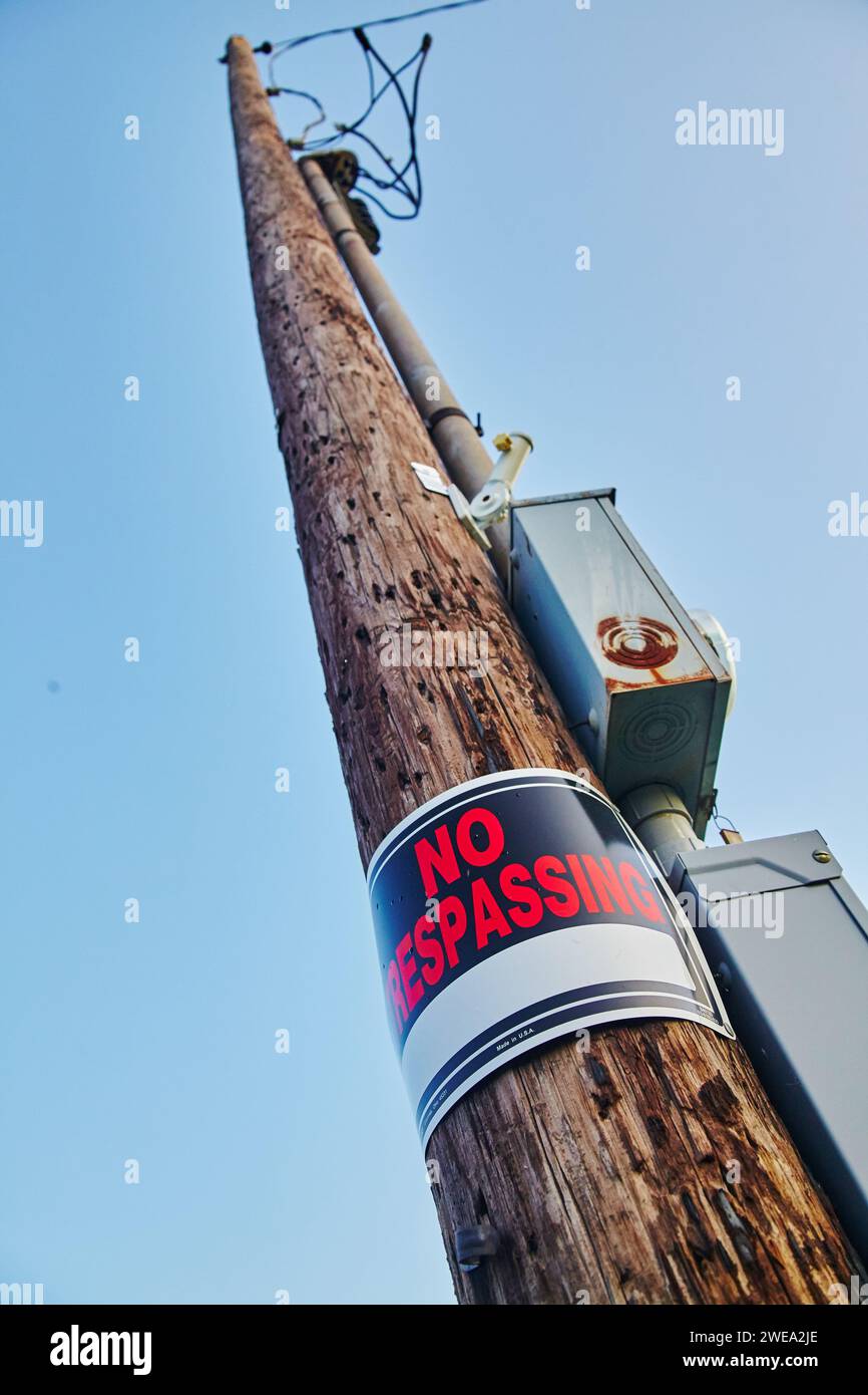 No Trespassing Sign on Weathered Utility Pole, Clear Sky Perspective ...