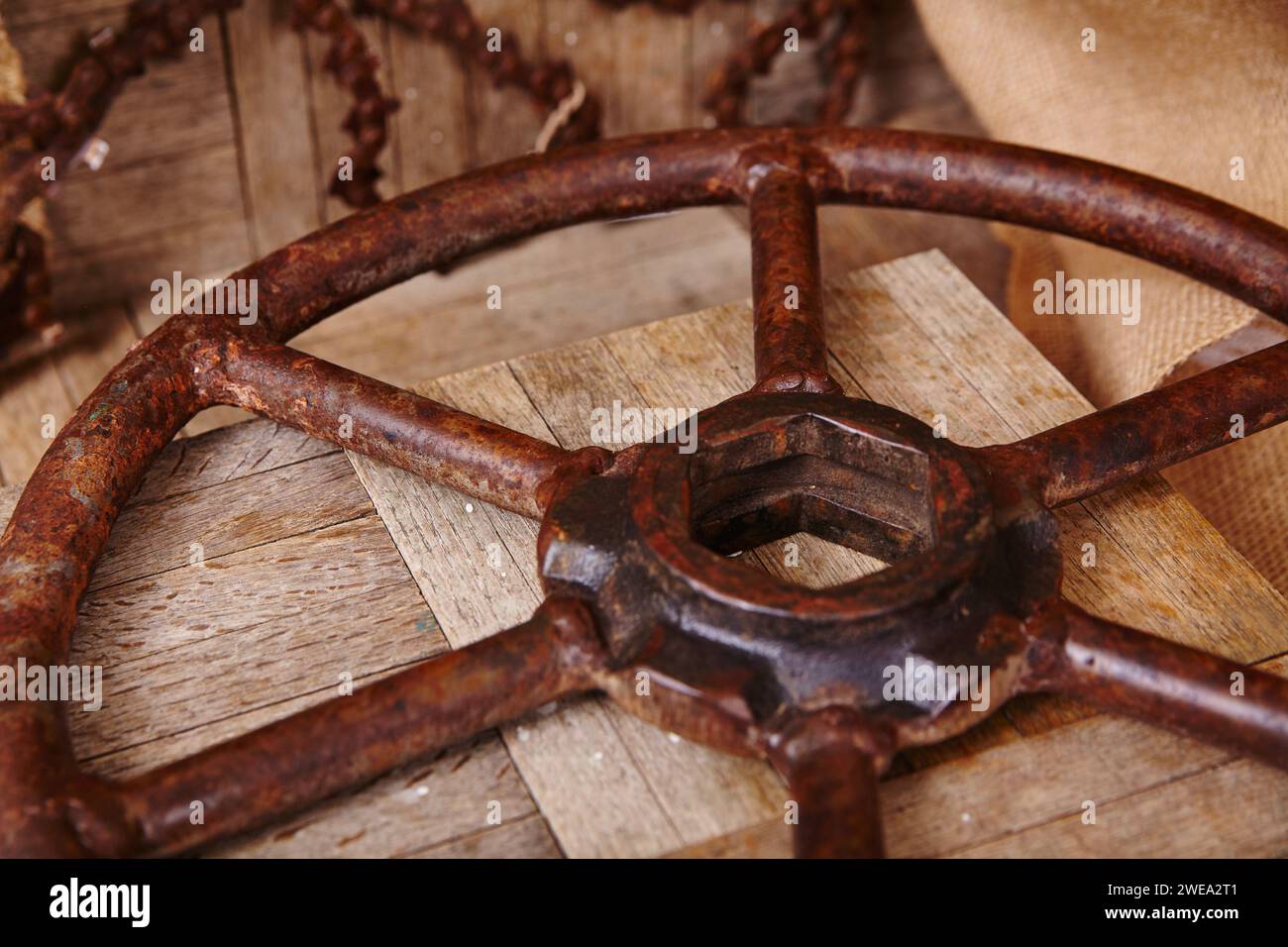 Vintage Rusted Metal Wheel on Weathered Wood with Industrial Chain ...