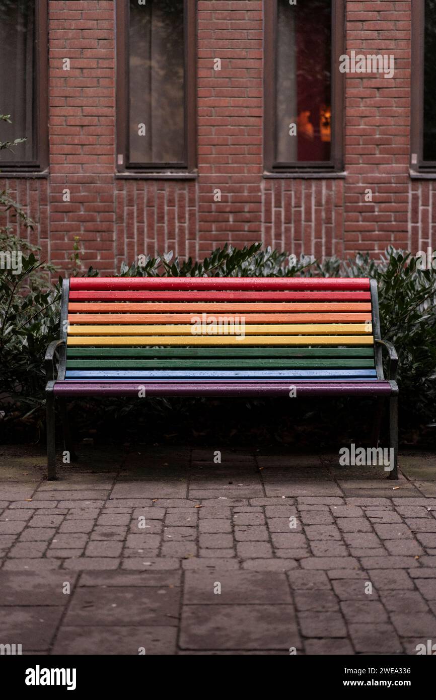 A rainbow coloured bench in a Swedish city in late afternoon Stock ...