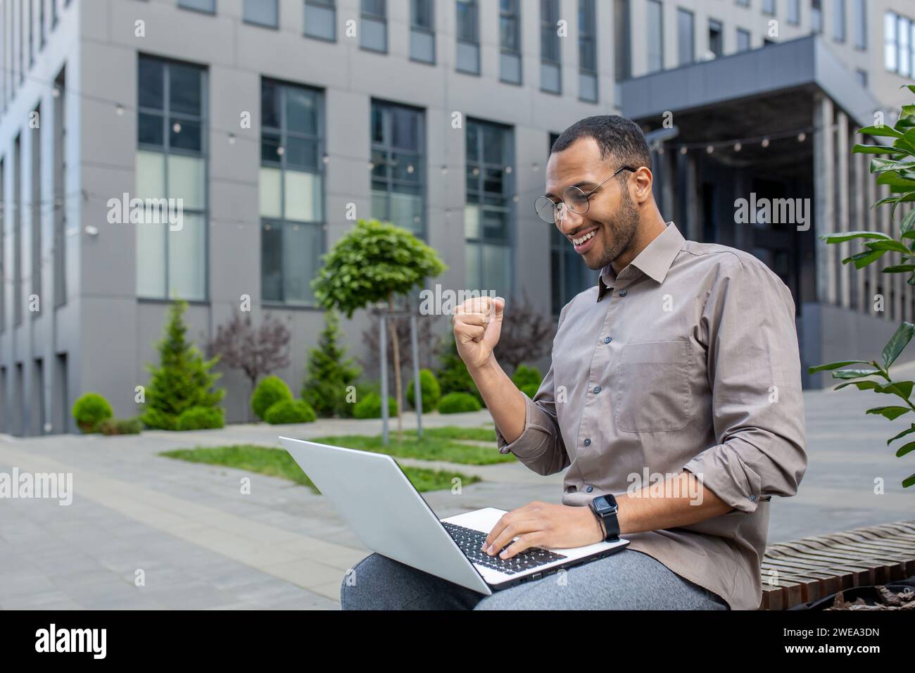 Man celebrating victory successful notification on laptop, businessman ...