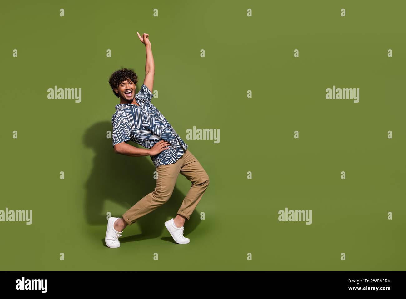 Full body size photo of funny crazy cool mexican guy pointing finger up ...