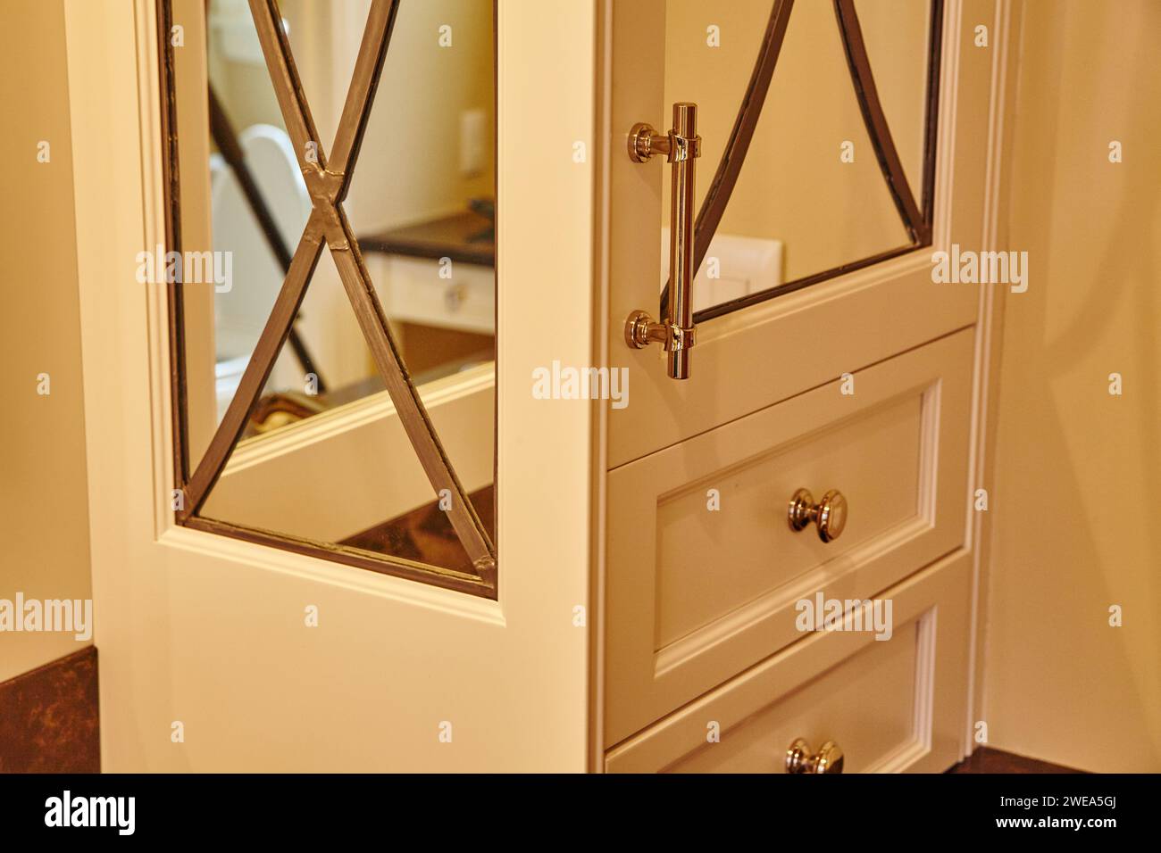 Elegant Cream Cabinet with Mirrored Doors and X-Pattern Detail Stock ...