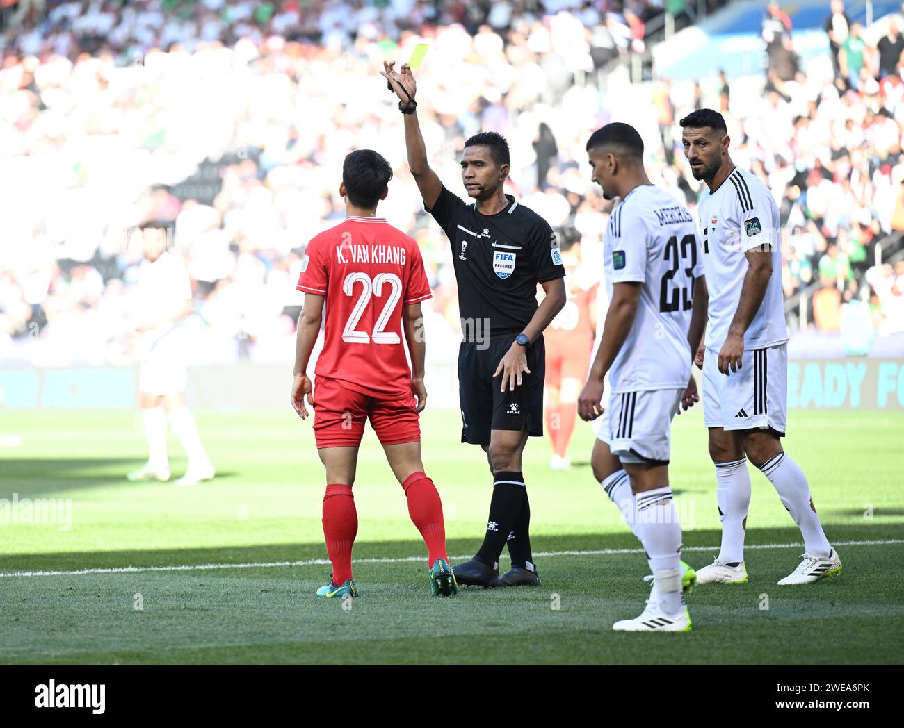 Doha. 24th Jan, 2024. Referee Muhammad Nazmi Nasaruddin (2nd L) shows a ...