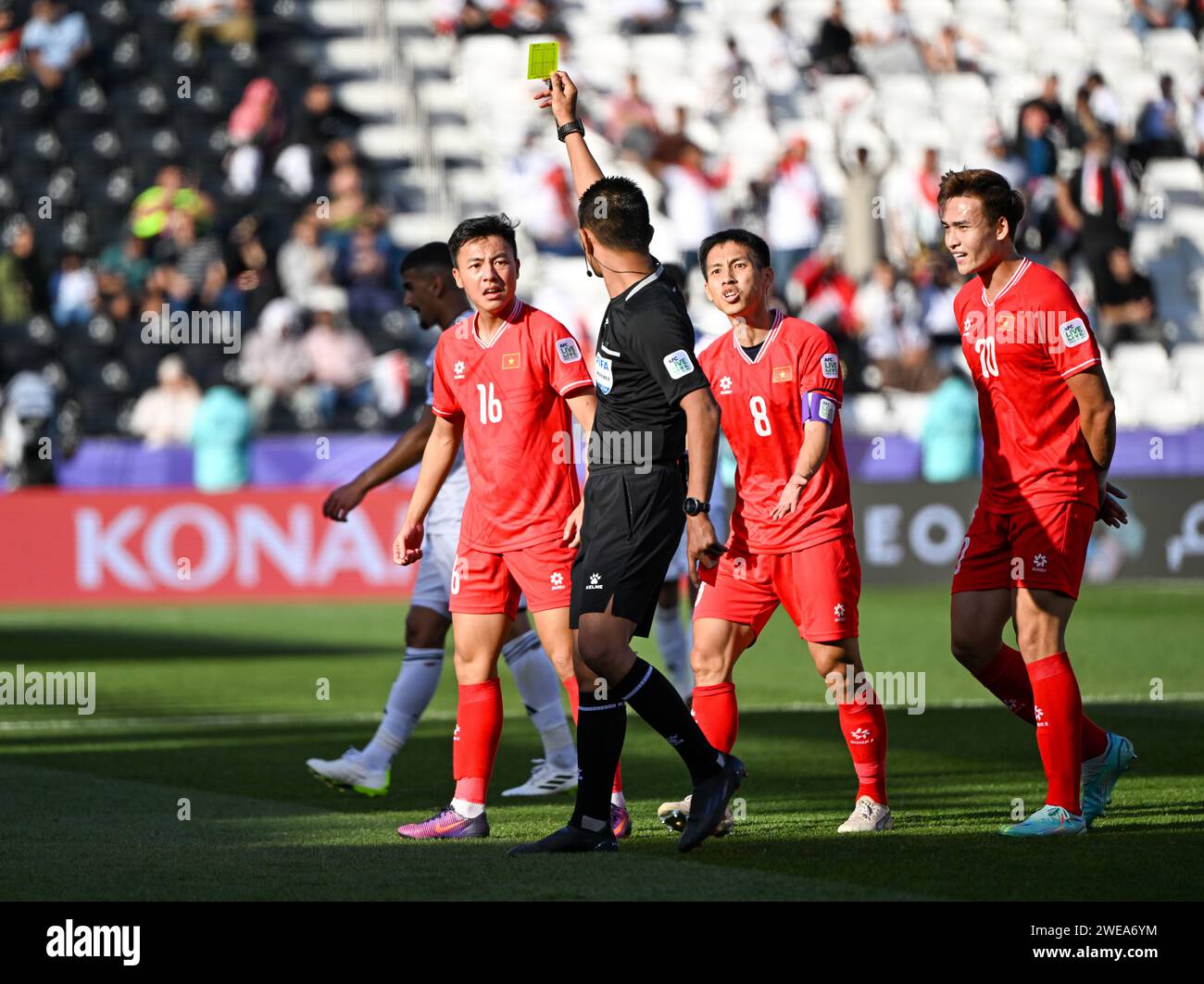 Doha. 24th Jan, 2024. Referee Muhammad Nazmi Nasaruddin (3rd R) shows a ...