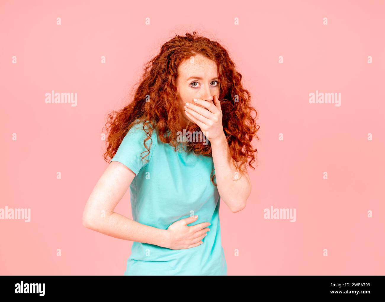 Red hair woman suffering from stomach ache and nausea on pink ...