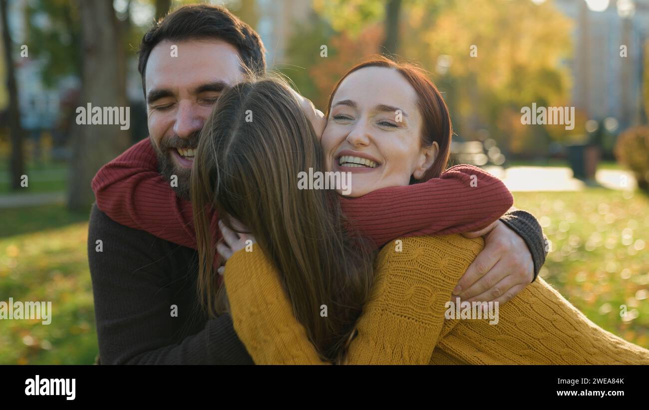 Happy family playing hugging in park sunny autumn mother father waiting ...