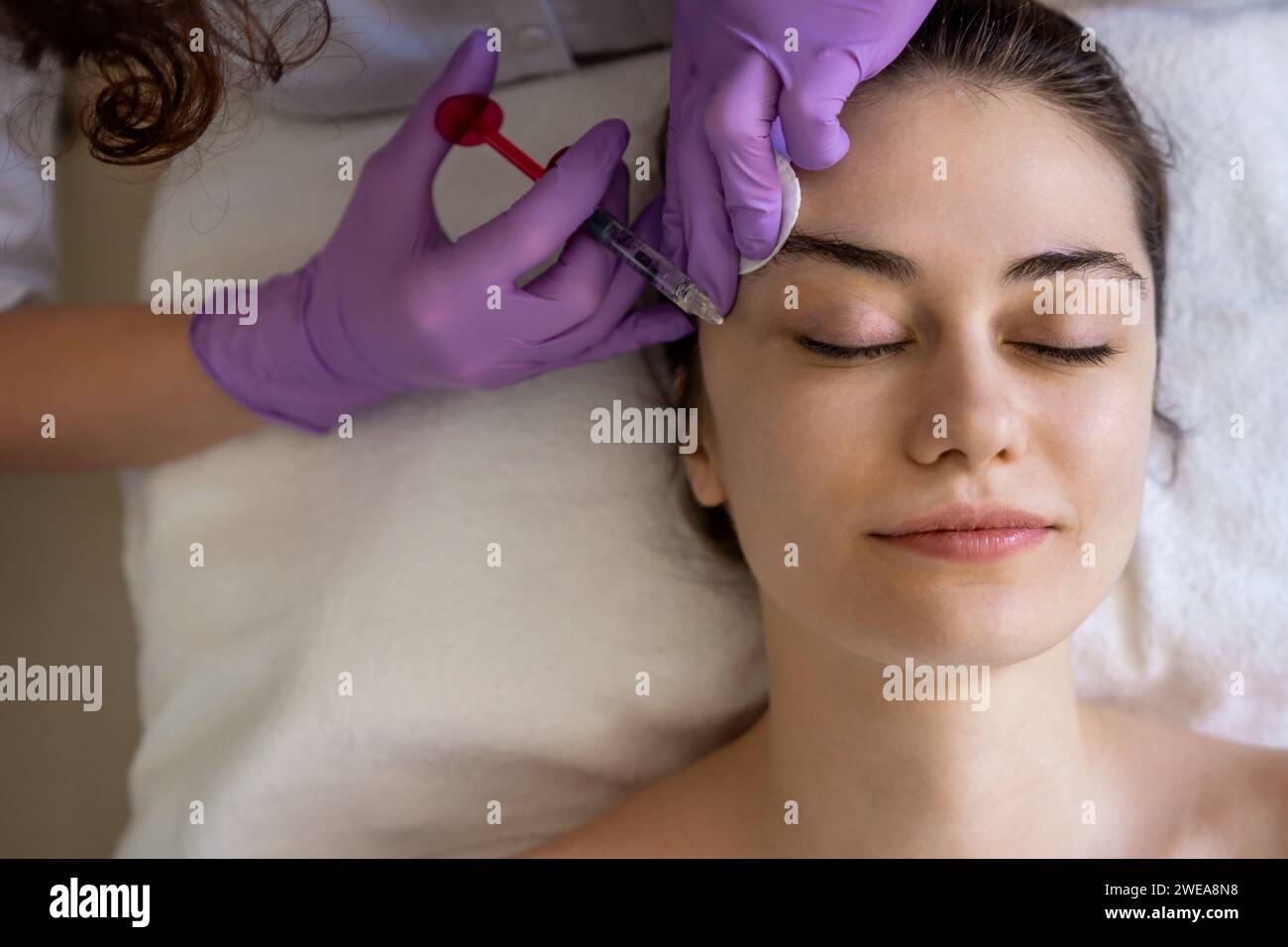 Hands of cosmetologist in gloves making rejuvenation anti wrinkle ...