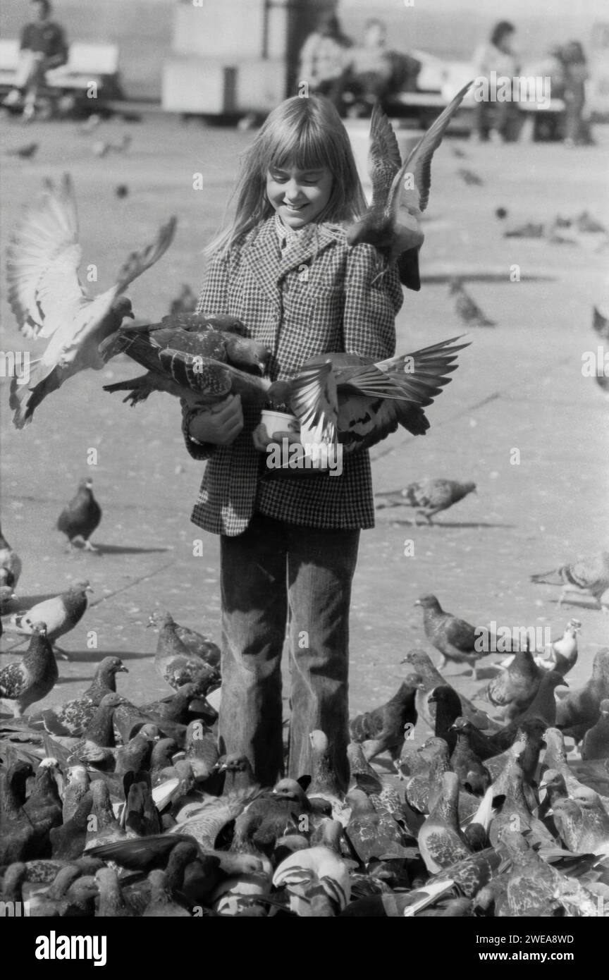 Young girl feeding pigeons in Trafalgar Square, London, circa 1979 ...