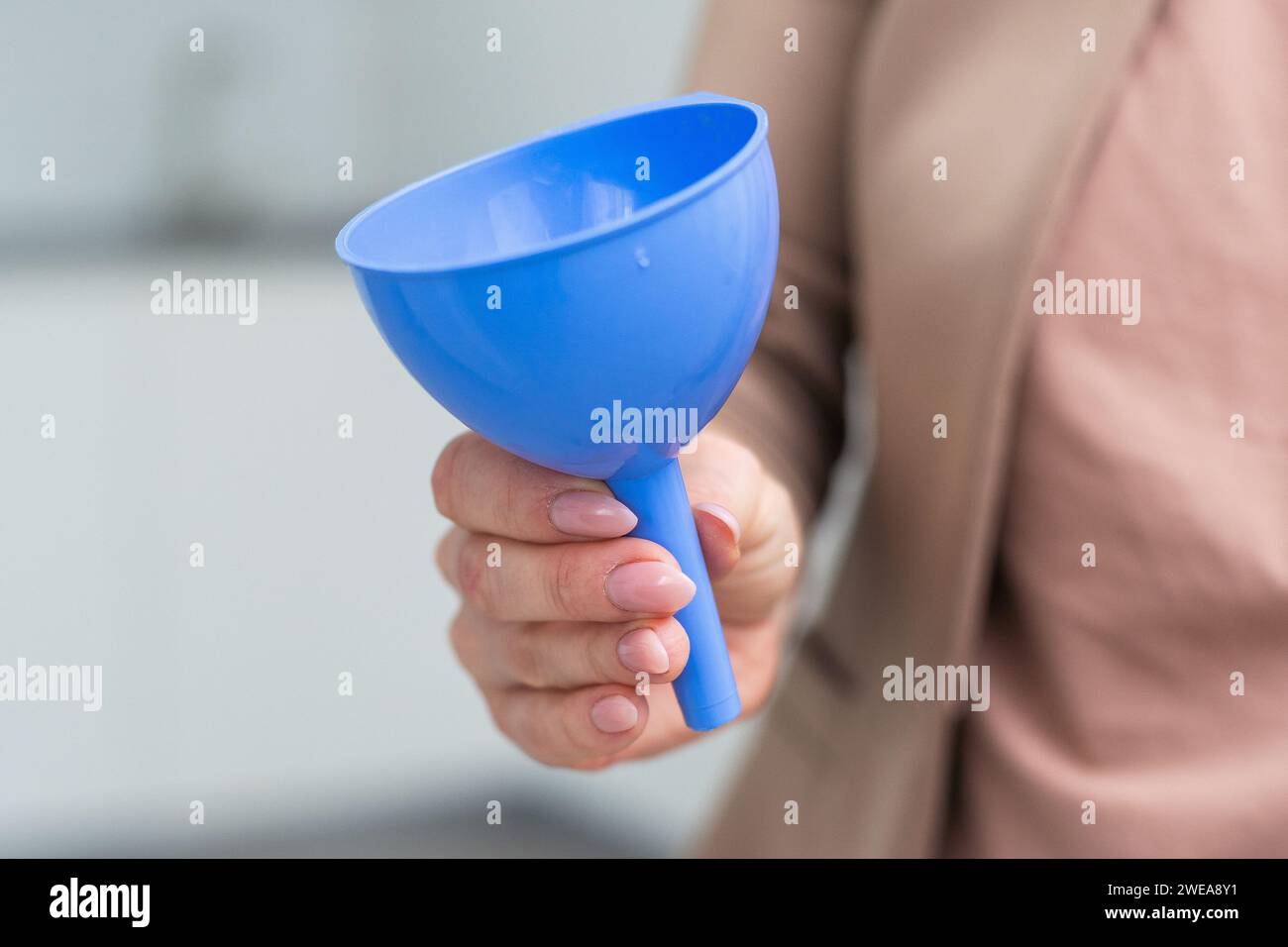 hand holds a funnel isolated on white background Stock Photo - Alamy