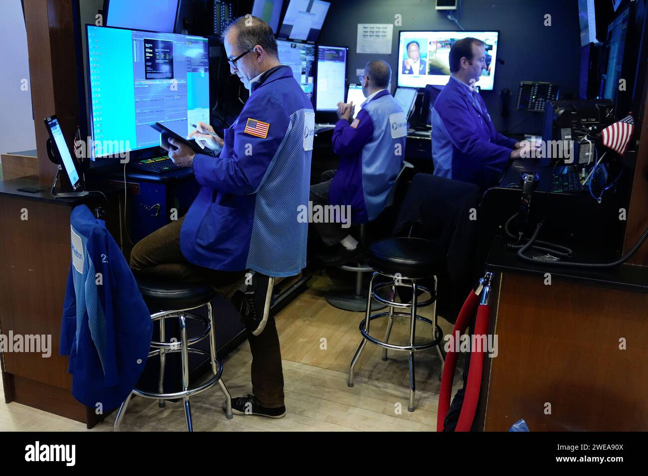 Traders work on the floor at the New York Stock Exchange in New York ...