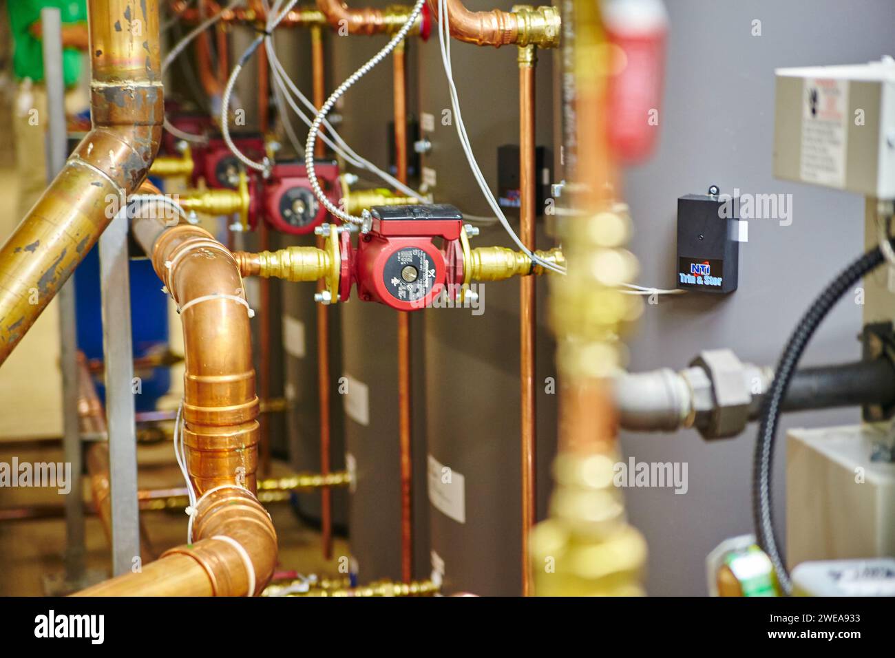 Industrial Copper Piping with Red Valve Close-Up Stock Photo - Alamy