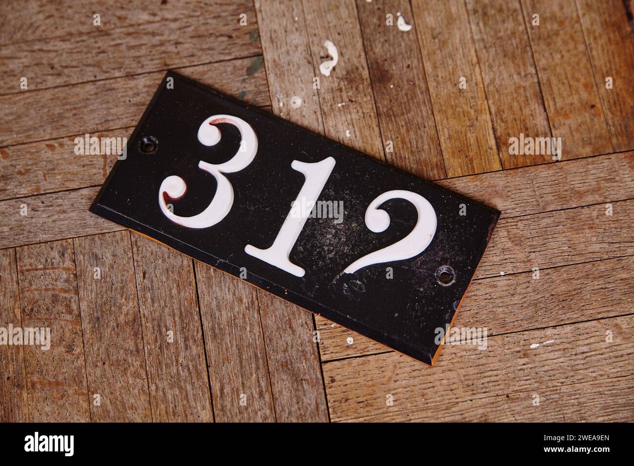 Vintage Number 312 Address Plaque on Textured Wooden Floor Stock Photo ...