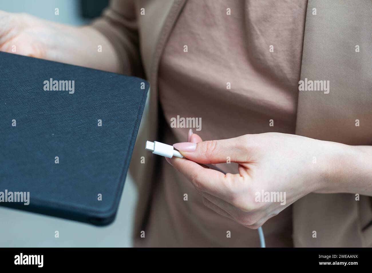 Hand holding Tablet charging power Stock Photo - Alamy
