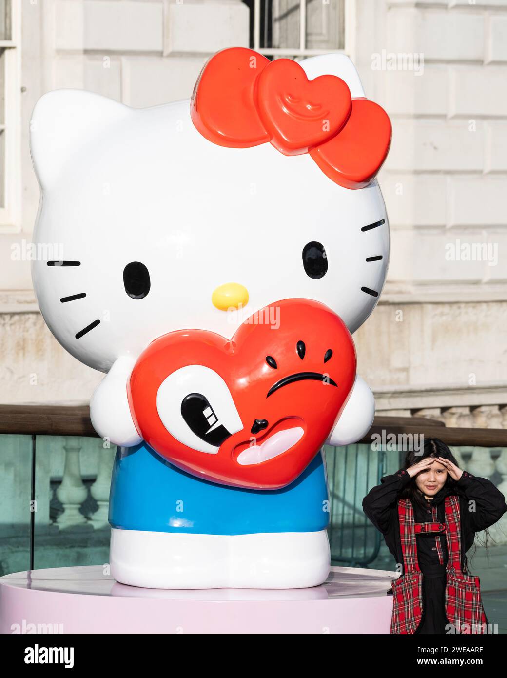 London, UK. 24 January 2024. A passer by next to 'Hello, Love', 2023, a ...