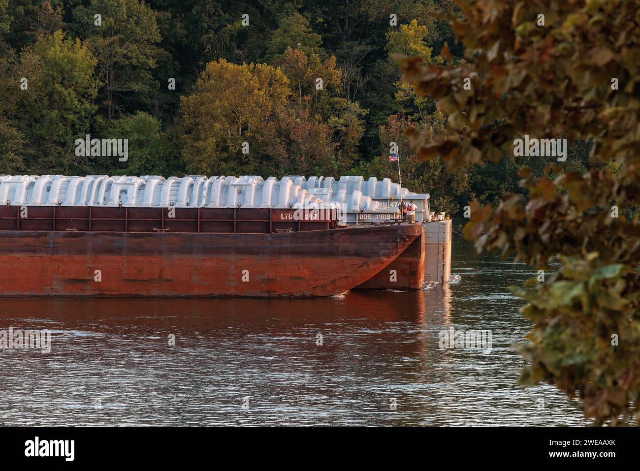 Deck hands place the American flag on a barge being pushed on the ...