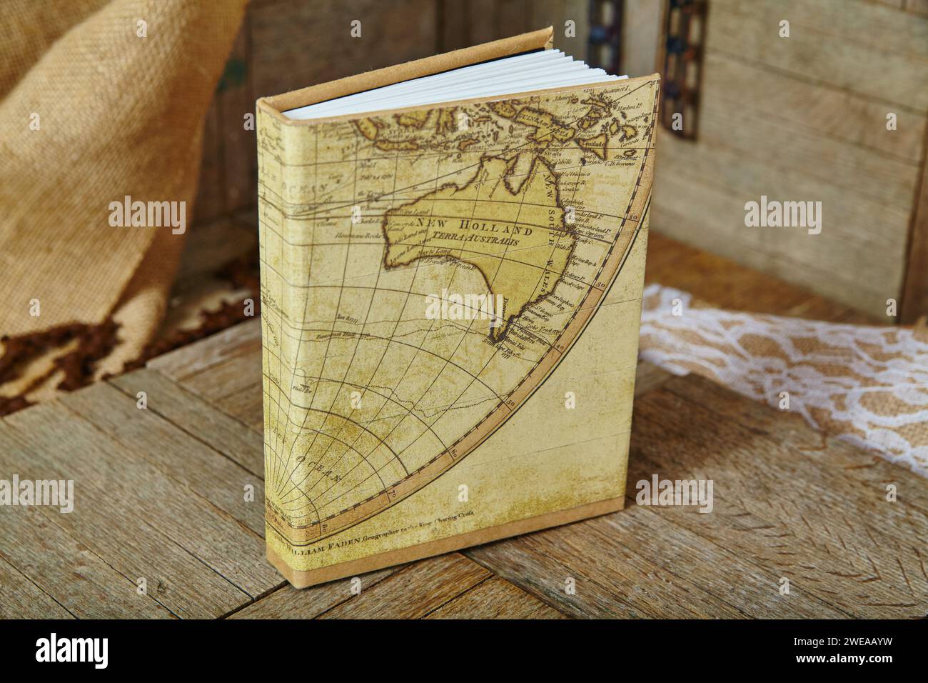 Vintage Map Book Cover on Rustic Wooden Surface with Lace Background ...