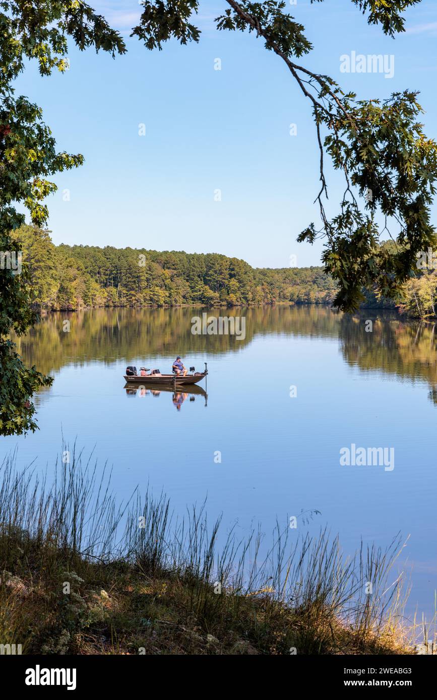 Man fishing in small boat on Pin Oak Lake in Natchez Trace State Park ...