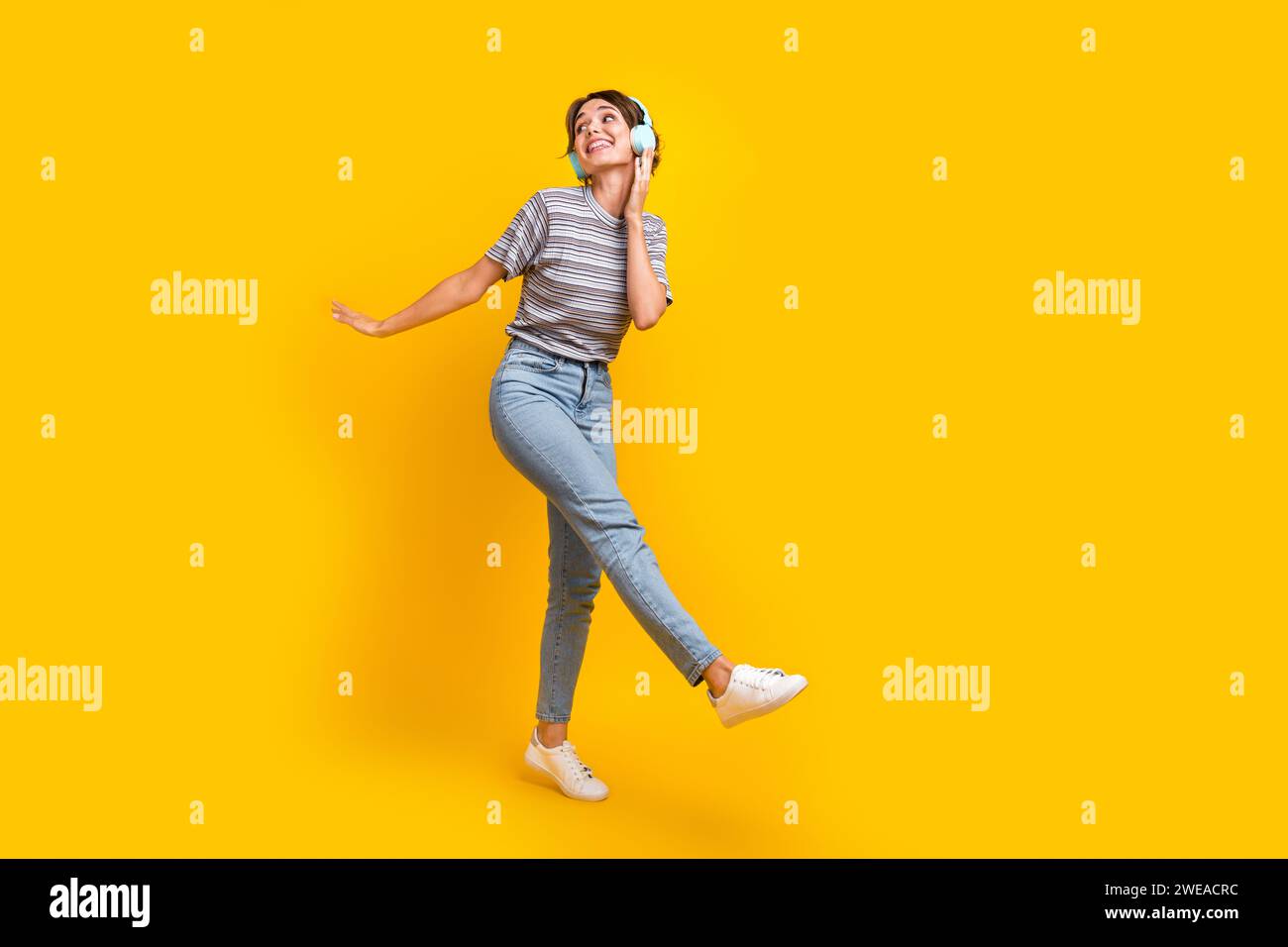 Full length photo of cheerful lovely person arm touch headphones ...