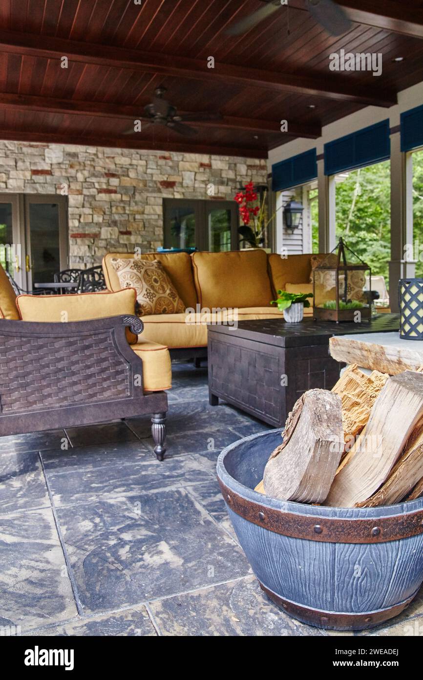 Elegant Outdoor Living Space with Plush Sofa and Firewood Basket Stock ...