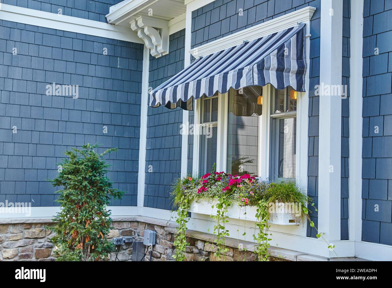 Cozy House Window with Blue Awning and Flower Box Stock Photo - Alamy