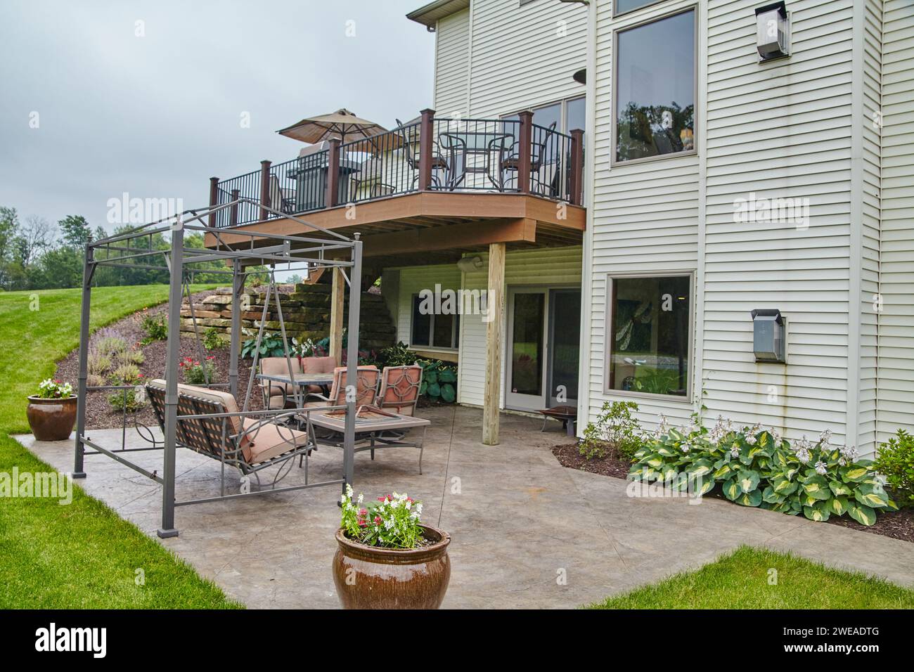 Modern Suburban Backyard with Deck, Swing Seat, and Landscaped Garden ...