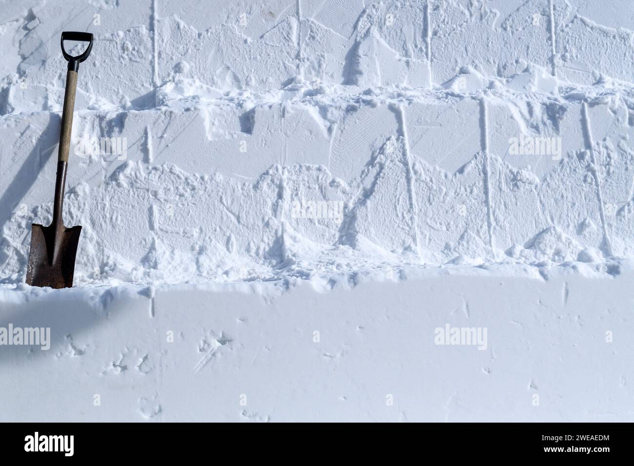 Using a shovel to start the process of constructing a snow sculpture ...