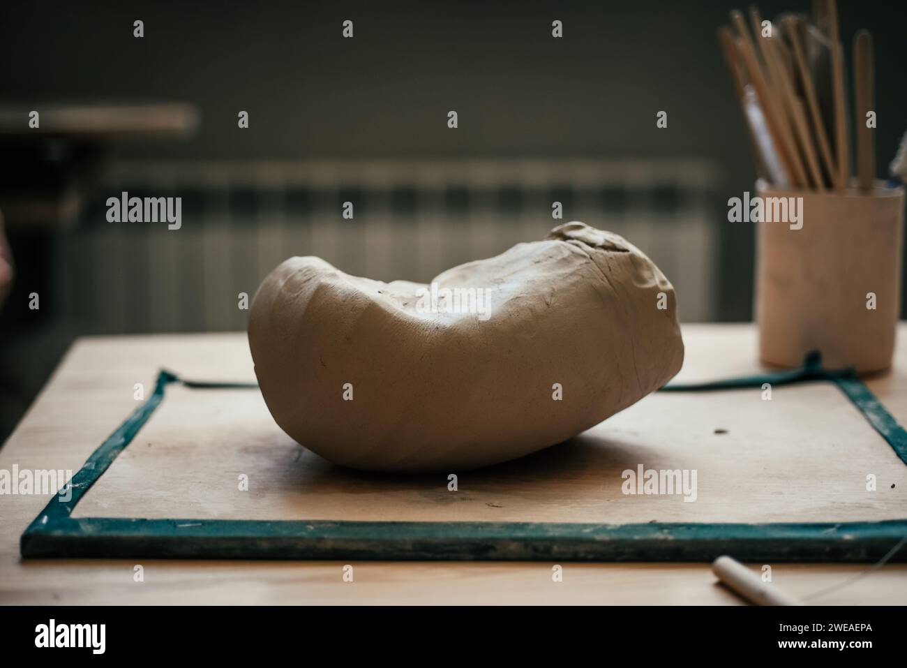 A piece of soft raw white clay on ceramists workbench Stock Photo - Alamy