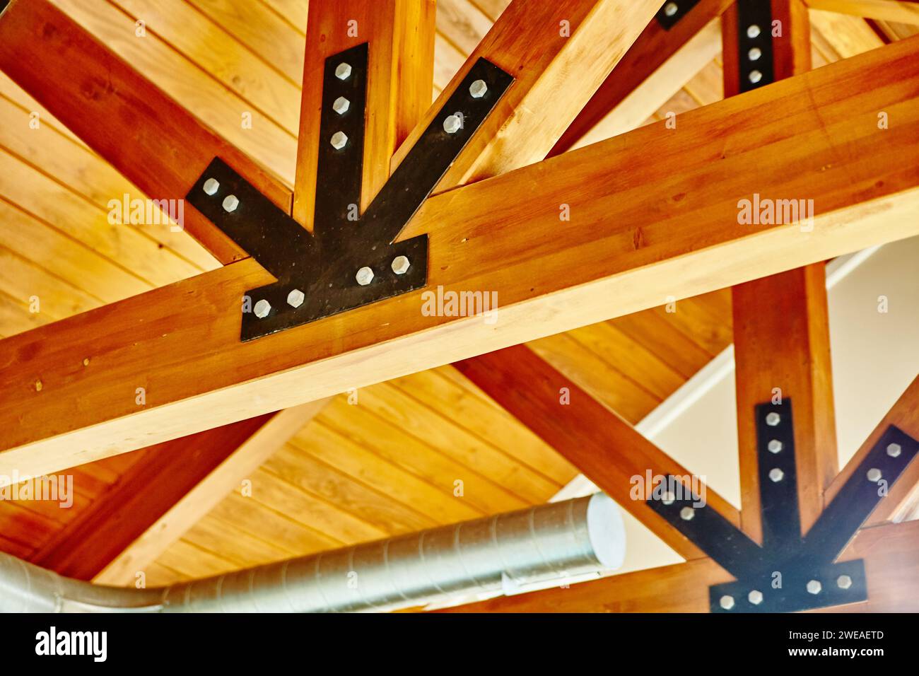 Warm Wooden Ceiling with Black Metal Brackets Detail Stock Photo - Alamy