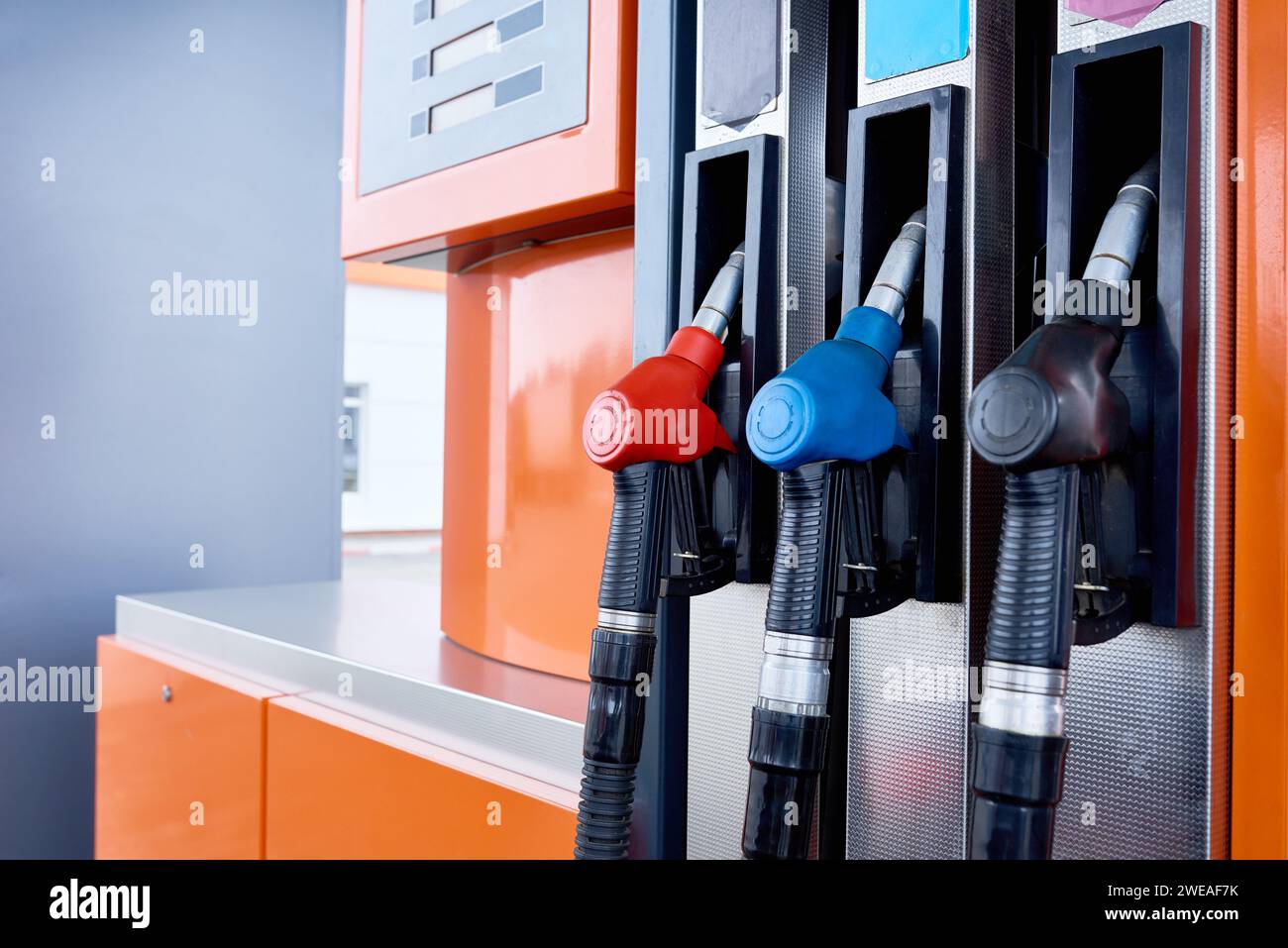 Close up background image of fuel pump with several nozzles in gas ...