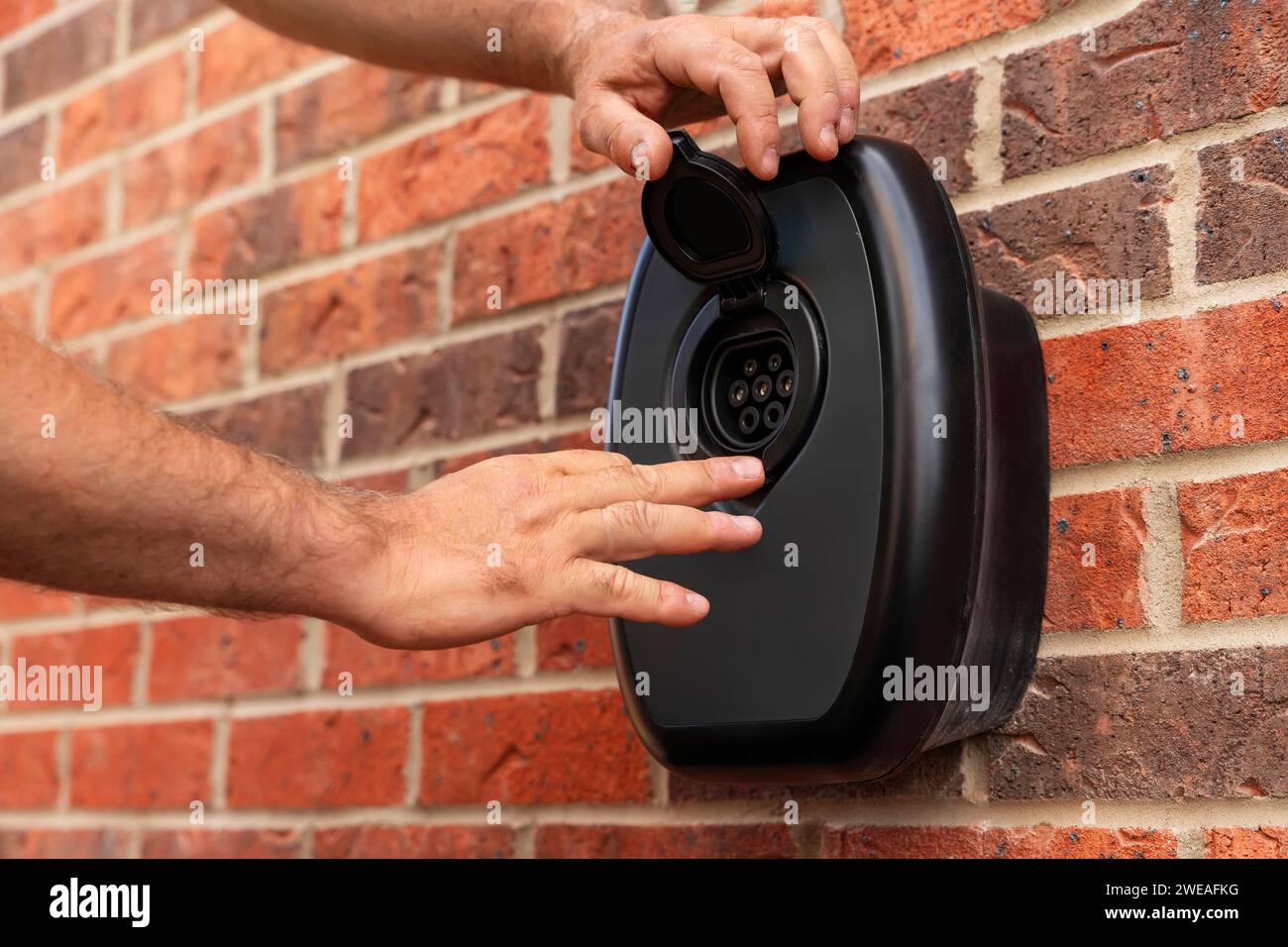 Electric vehicle domestic charging point installed outside of the house ...
