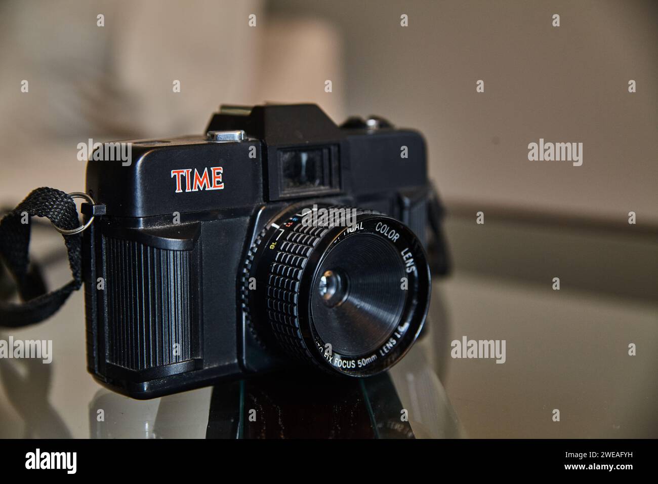 Vintage Film Camera with 50mm Lens on Reflective Surface Stock Photo ...