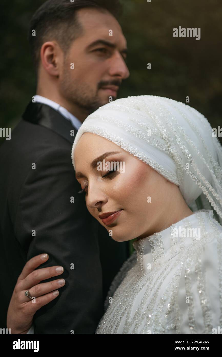 Newly married bride and groom standing in forest and posing Stock Photo ...