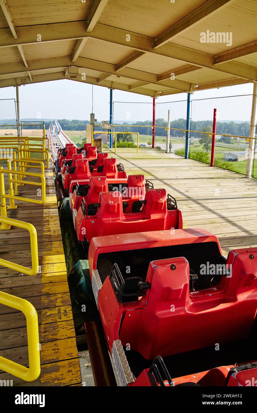 Empty Red Roller Coaster Cars at Rural Amusement Park, Eye-Level View ...