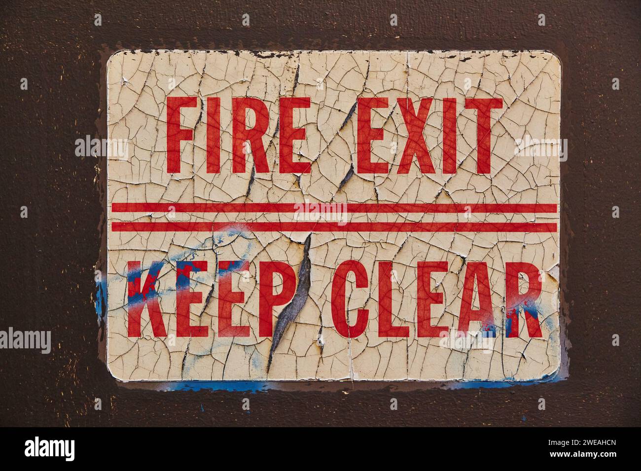 Distressed Fire Exit Sign on Dark Wall - Vintage Safety Neglect Stock ...