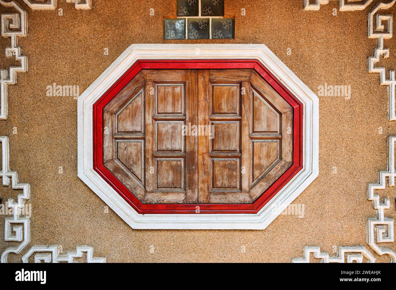 Wooden ancient oriental window on chinese stone wall Stock Photo - Alamy