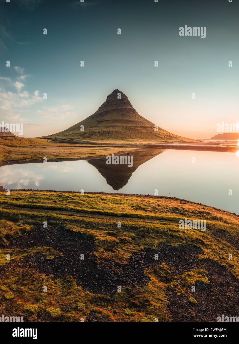 Beautiful aerial view of Kirkjufell volcanic mountain reflect on lake ...
