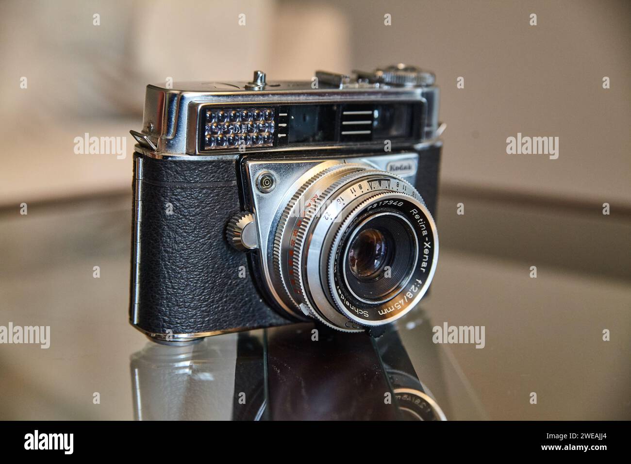 Vintage Film Camera on Reflective Surface, Eye-Level View Stock Photo ...