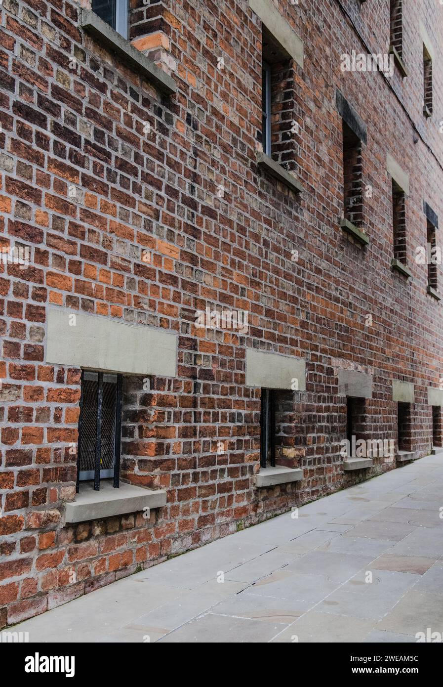 Victorian red brick warehouse barred windows at the historic docks at ...