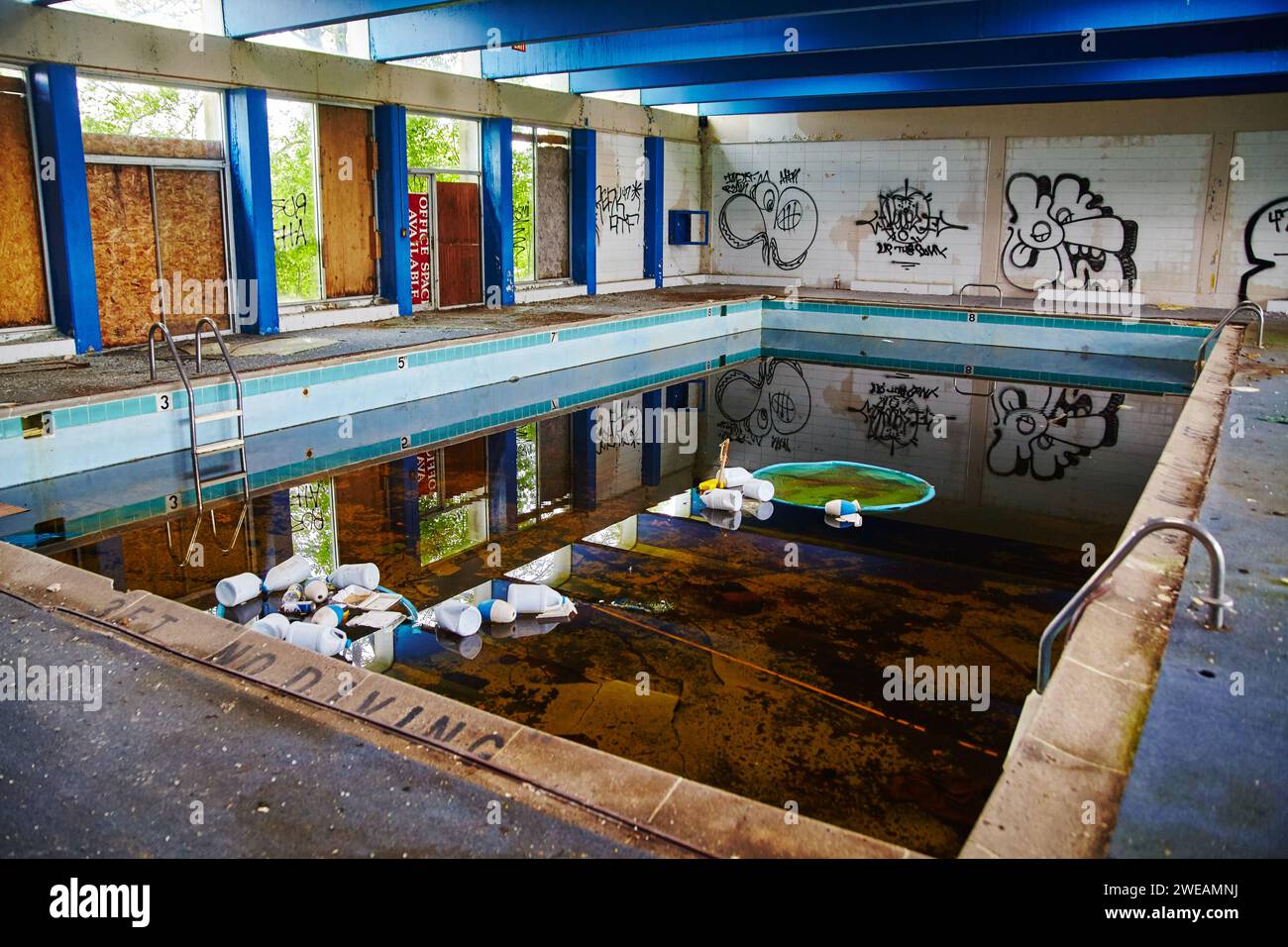 Abandoned Swimming Pool with Graffiti and Debris, Urban Decay Scene ...