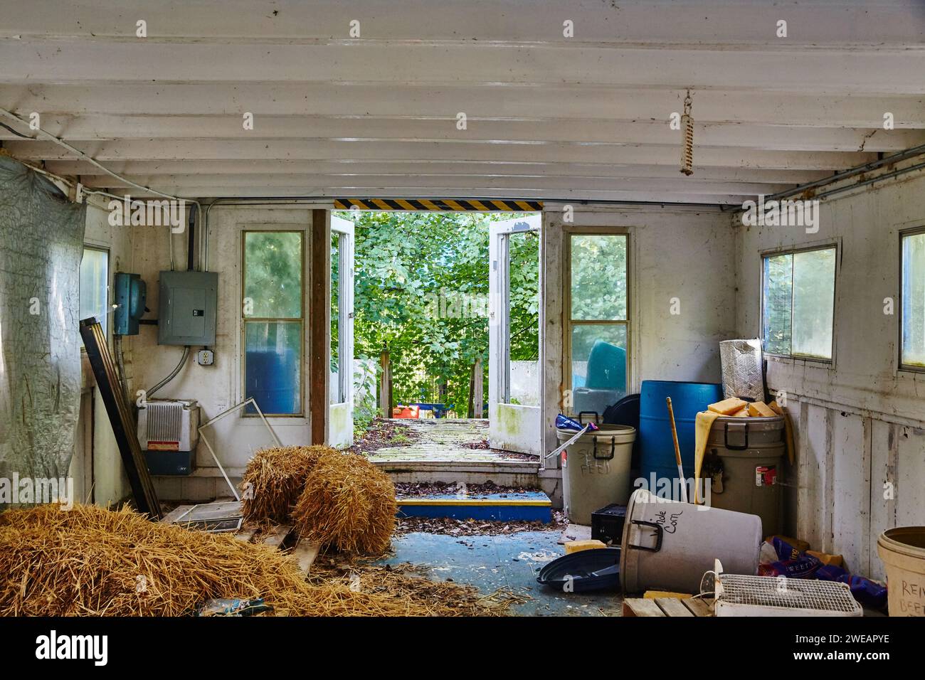 Rustic Barn Interior with Hay and Farming Supplies, Countryside View ...