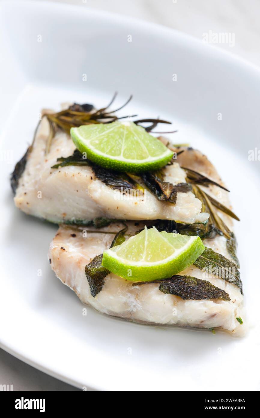 white fish fillet baked with herbs Stock Photo - Alamy