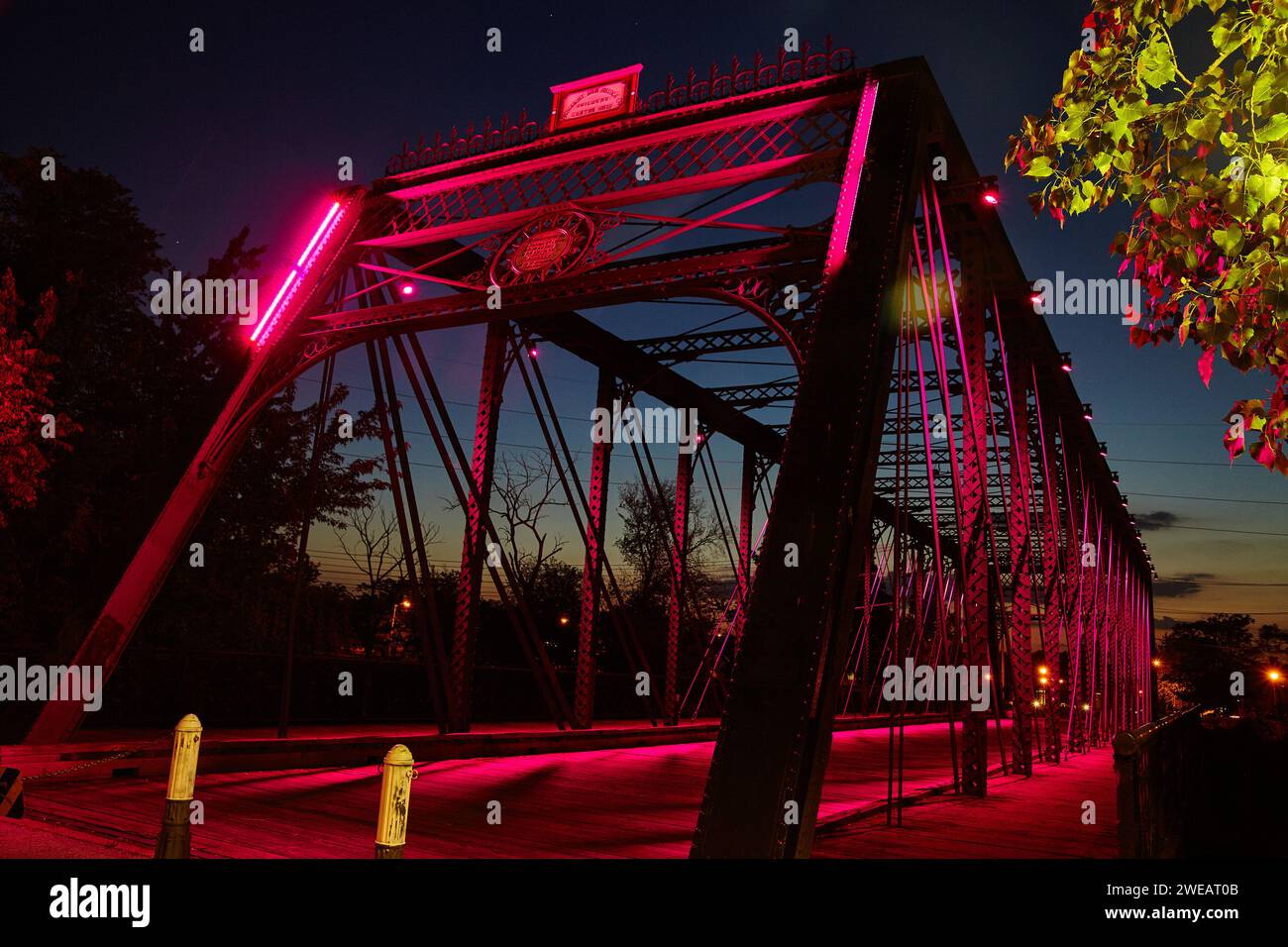 Illuminated Historic Truss Bridge at Twilight with Greenery Stock Photo ...