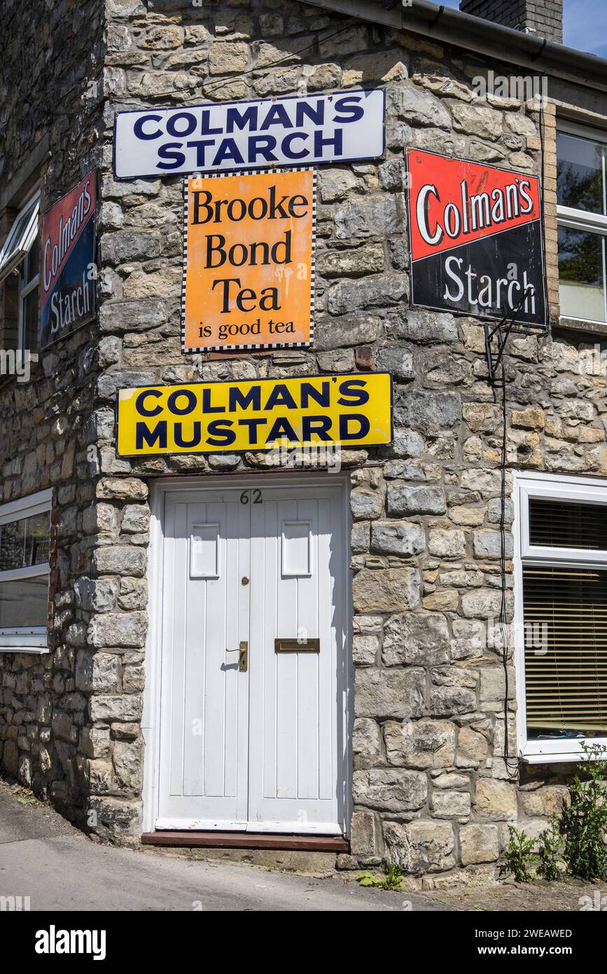 Corner house with antique shop advertisements, Bridgend, Wales, UK ...
