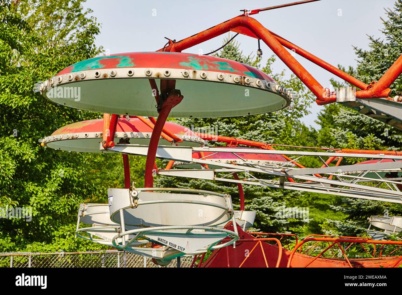 Vintage Amusement Park Ride with Rustic Charm, Green Canopy Background ...
