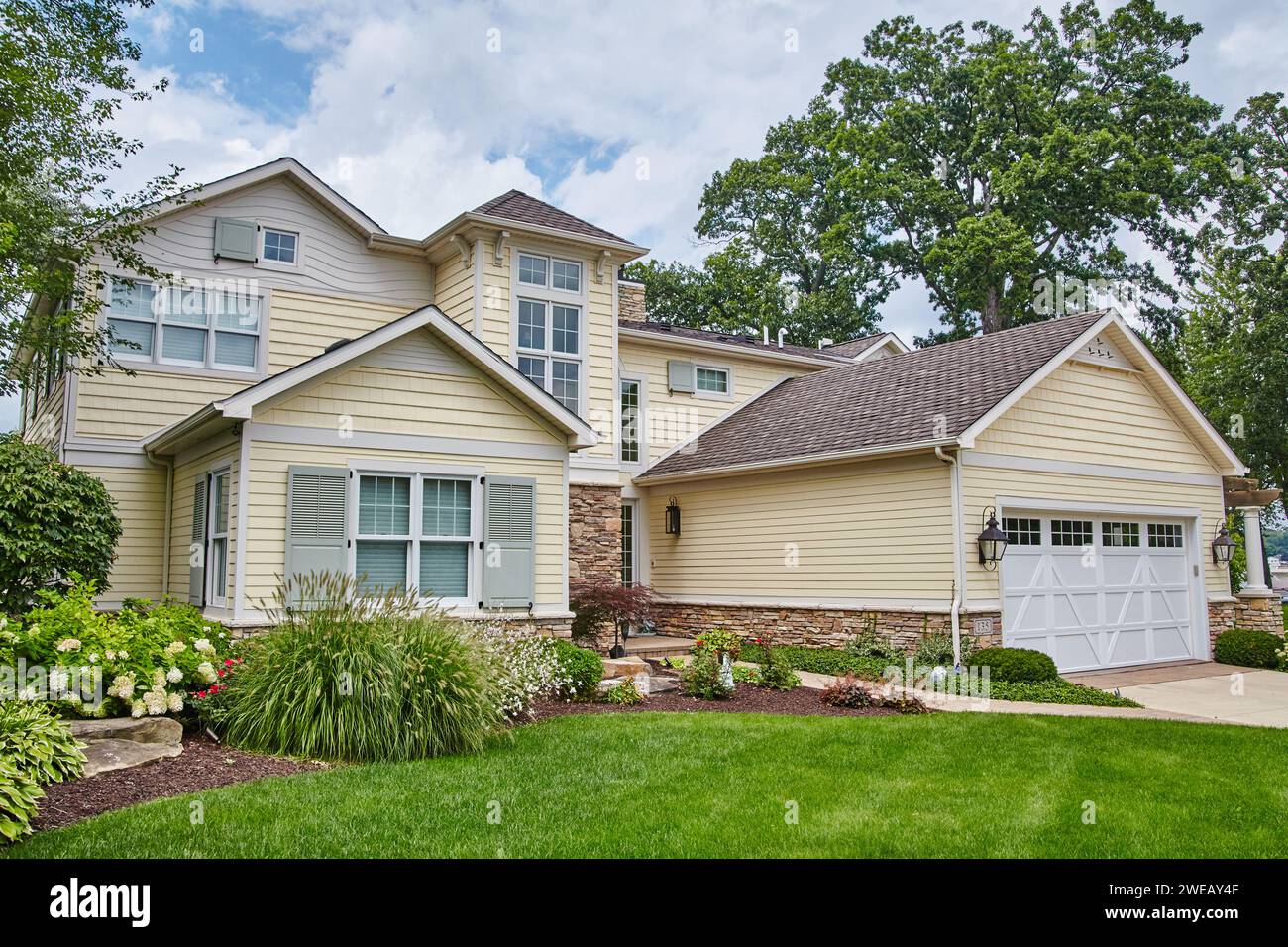 Suburban Home with Landscaping and Gable Roof, Daytime View Stock Photo ...