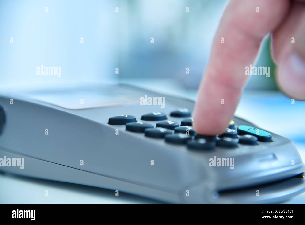 Finger dials pin code on pos terminal. Payment on pos terminal. Close ...