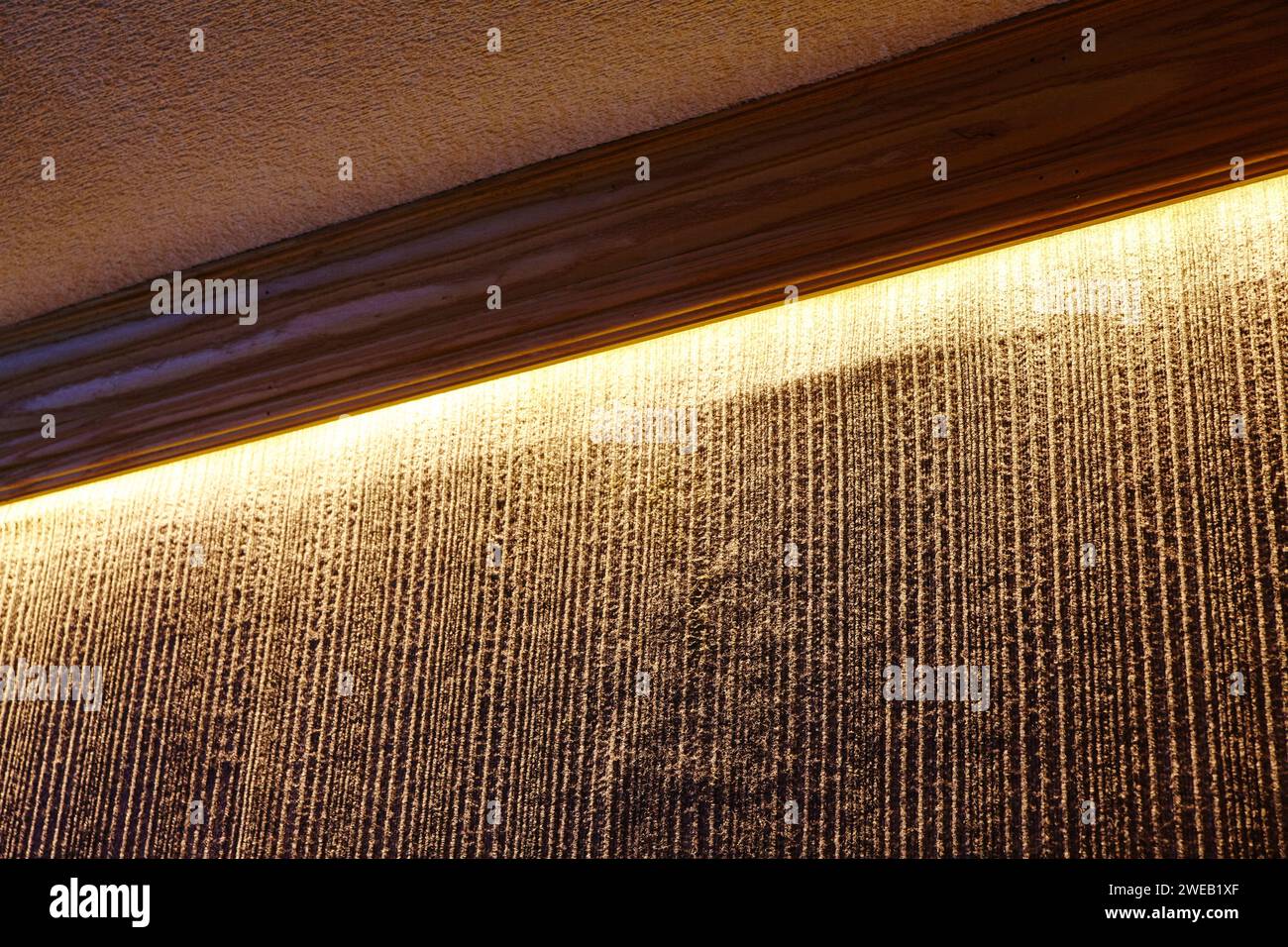 Luxurious Golden Wall Feature with Textured Backdrop and Ambient Light ...
