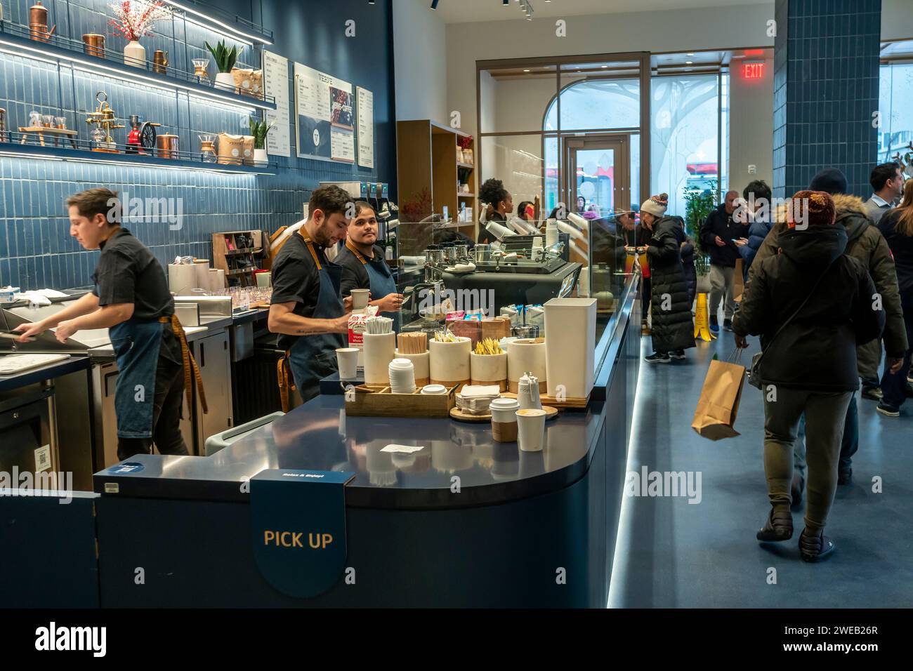 Customers and potential customers celebrate the grand opening of a ...